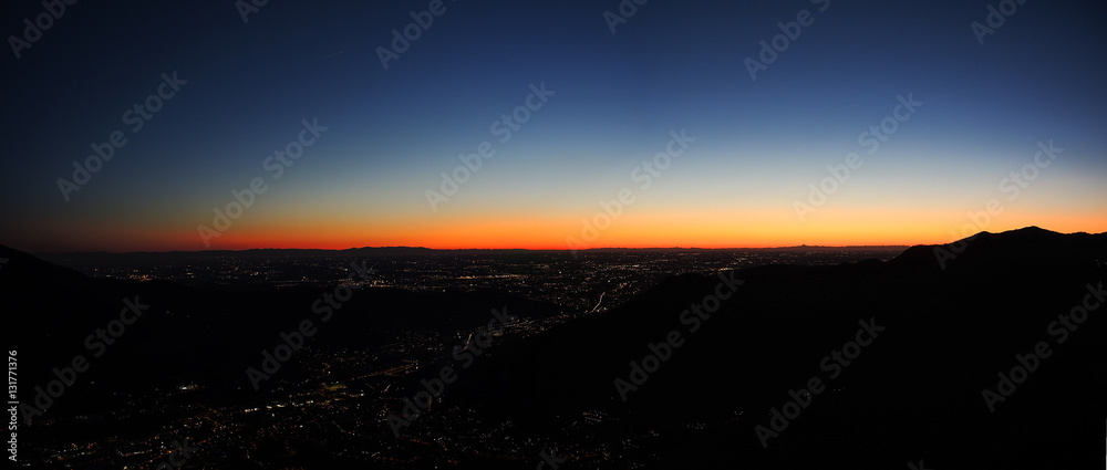 Fiery sunset from mountain pick with thin glazes in the sky evening ...