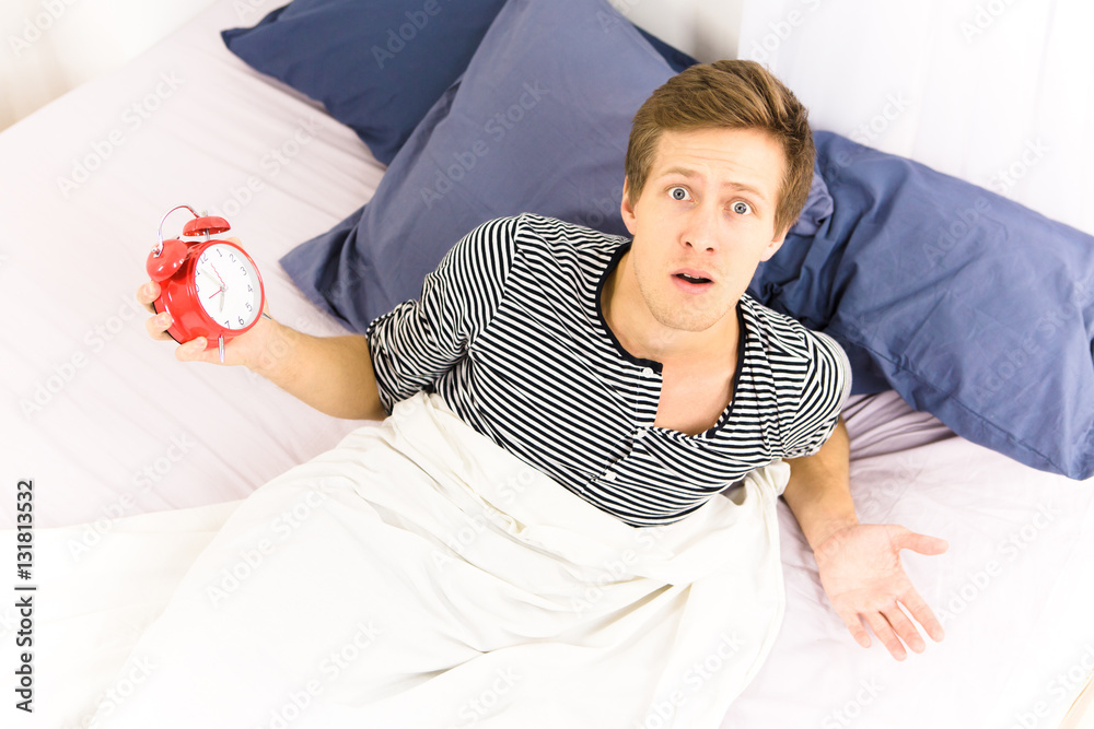Top View Of Handsome Man Lying With Alarm Clock In Bed Surprised Man