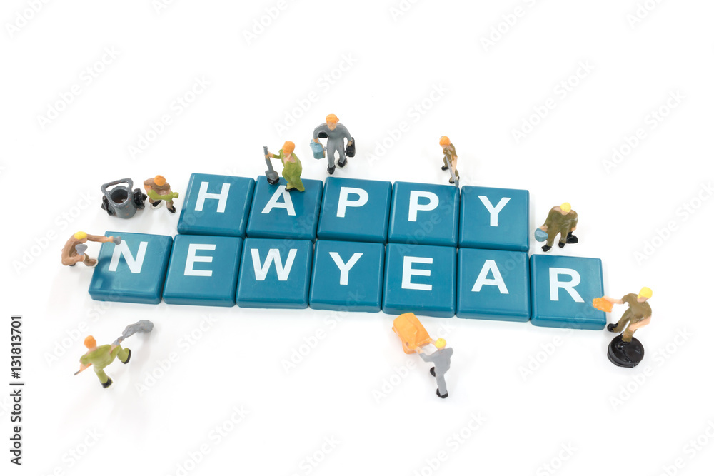 Miniature worker team building word happy new year on white background ...