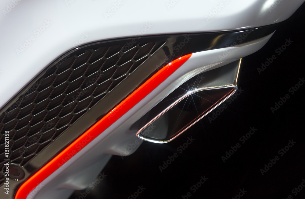 Chrome exhaust pipe of powerful sport car with white bodywork, orange ...