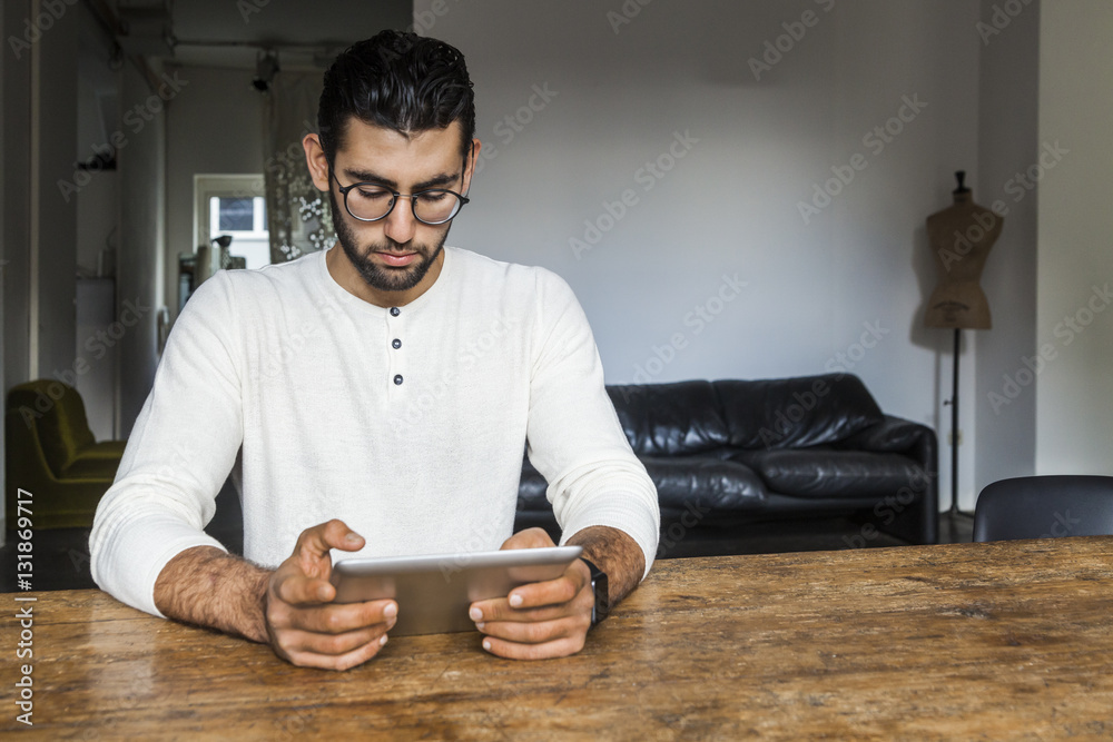 Young man using digital tablet in modern office Stock Photo | Adobe Stock