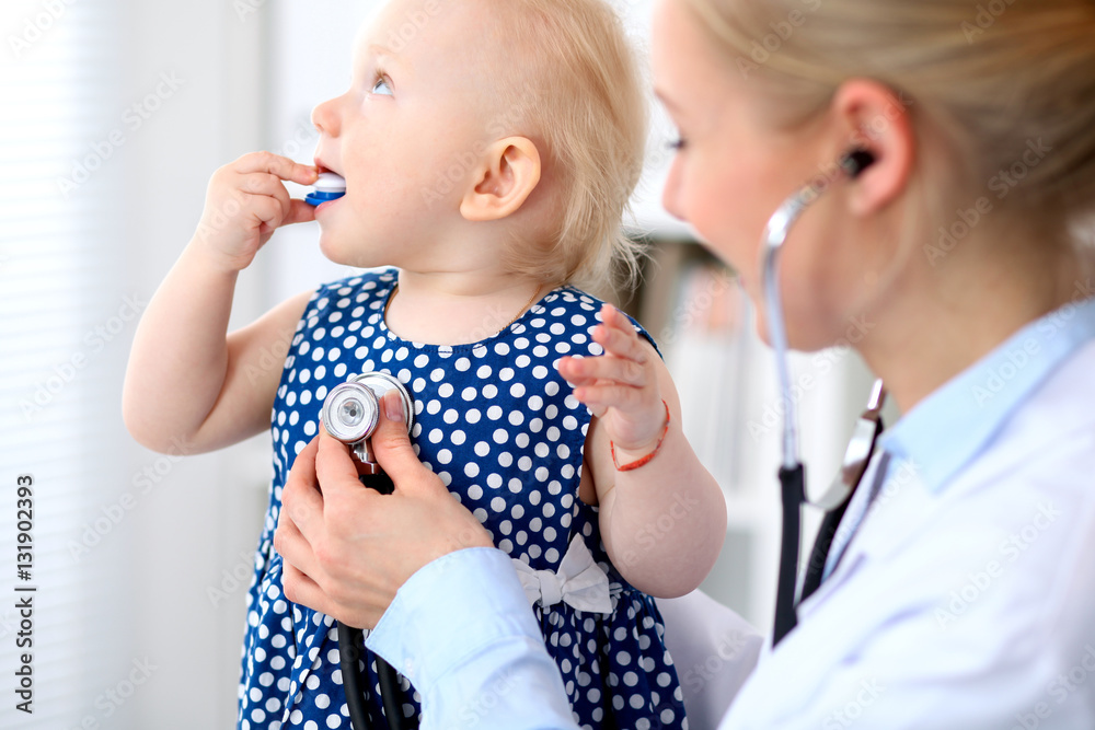 Pediatrician is taking care of baby in hospital. Little girl is being ...