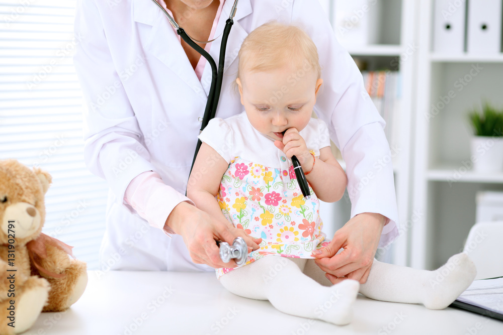 Pediatrician is taking care of baby in hospital. Little girl is being ...