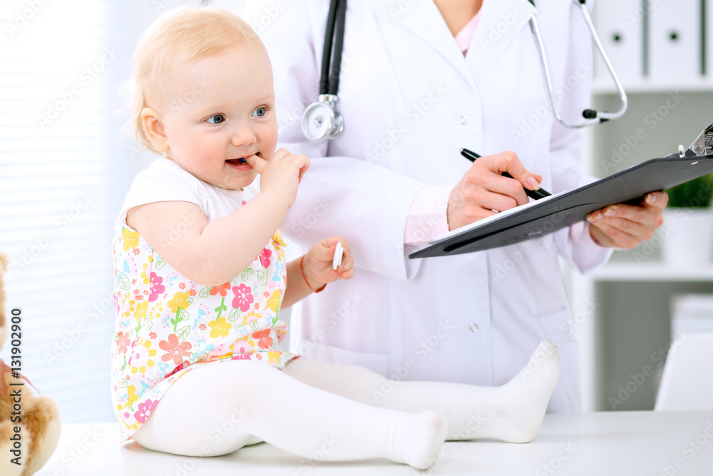 Pediatrician is taking care of baby in hospital. Little girl is being ...