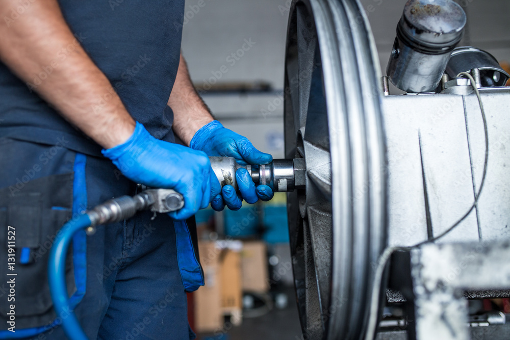 Mechanic fixing a compressor engine Stock Photo | Adobe Stock