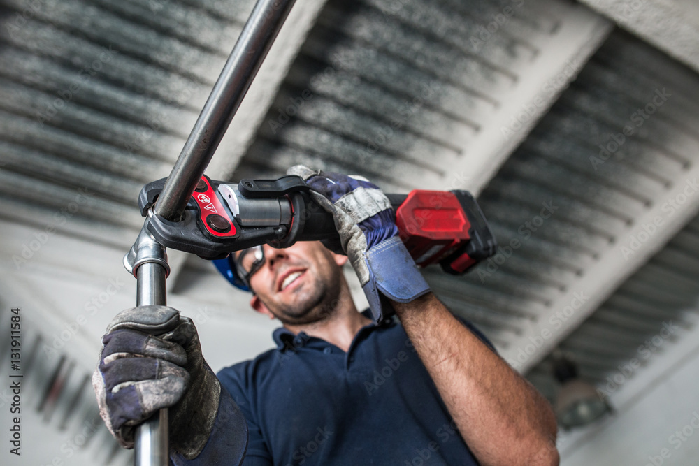 Mechanic joining pipes Stock Photo | Adobe Stock