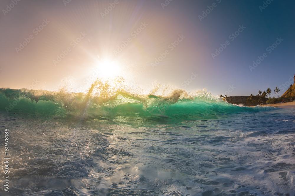 Breaking transparent clear ocean wave with green shining water lit with ...