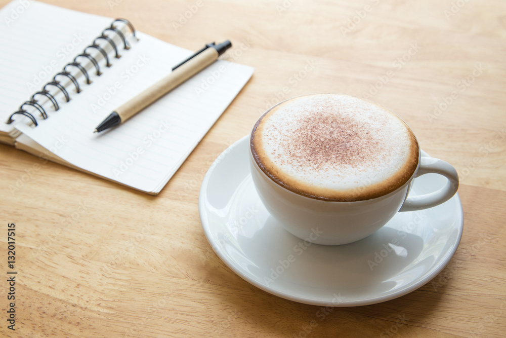 Open notebook with coffee cup. Stock Photo | Adobe Stock