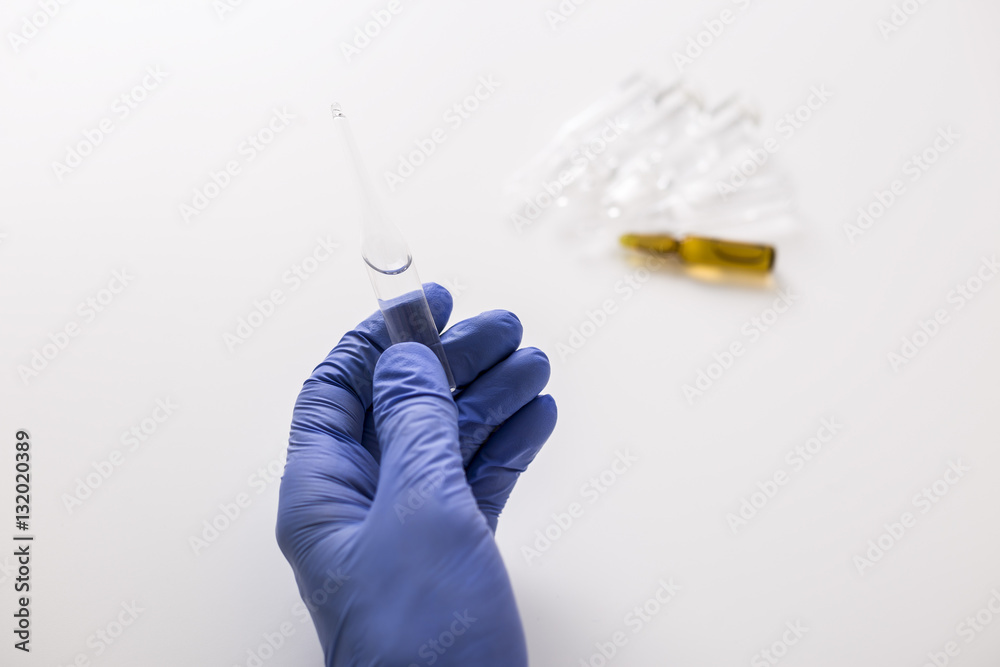 Man's hand holding a vial with medicine Stock Photo | Adobe Stock