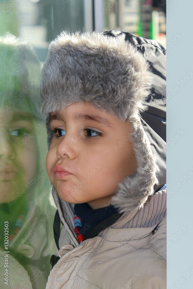 The boy looks through the shop window Stock Photo | Adobe Stock