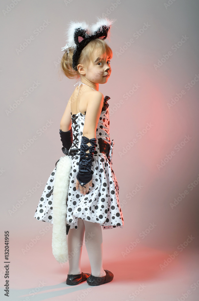 Attractive little girl dressed as a cat on a gray background. Stock ...
