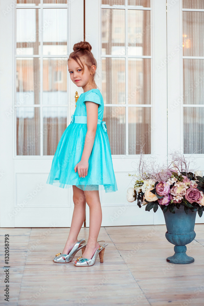 Little girl wearing mother's shoes. Stock Photo | Adobe Stock