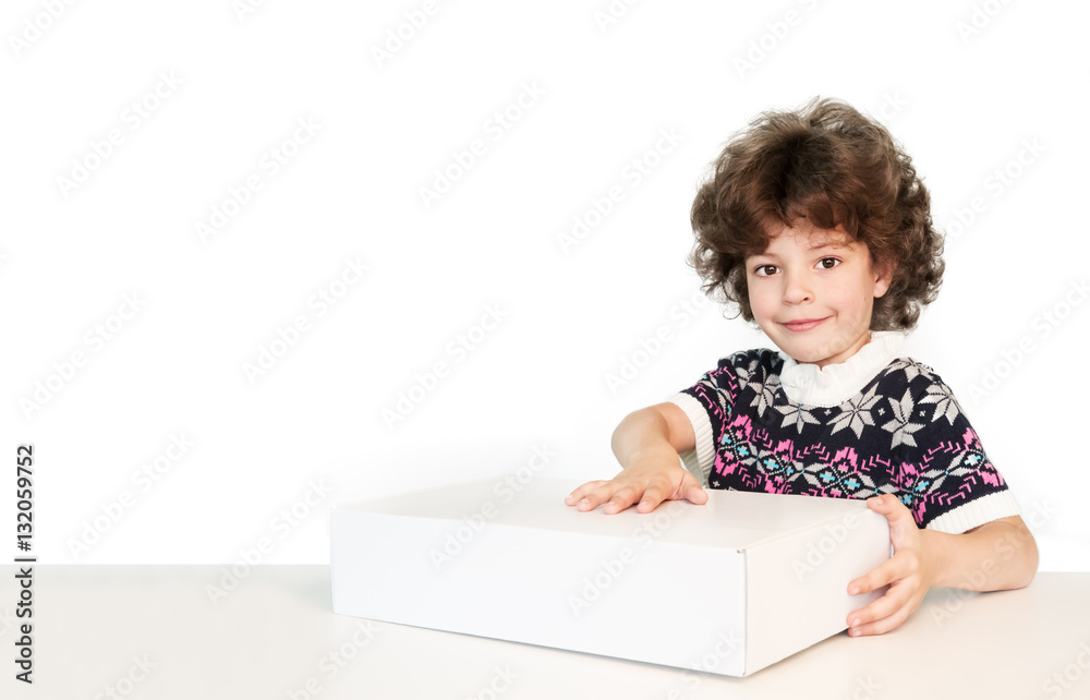 Surprised cute boy put his hand on the white box, smiling and looking ...