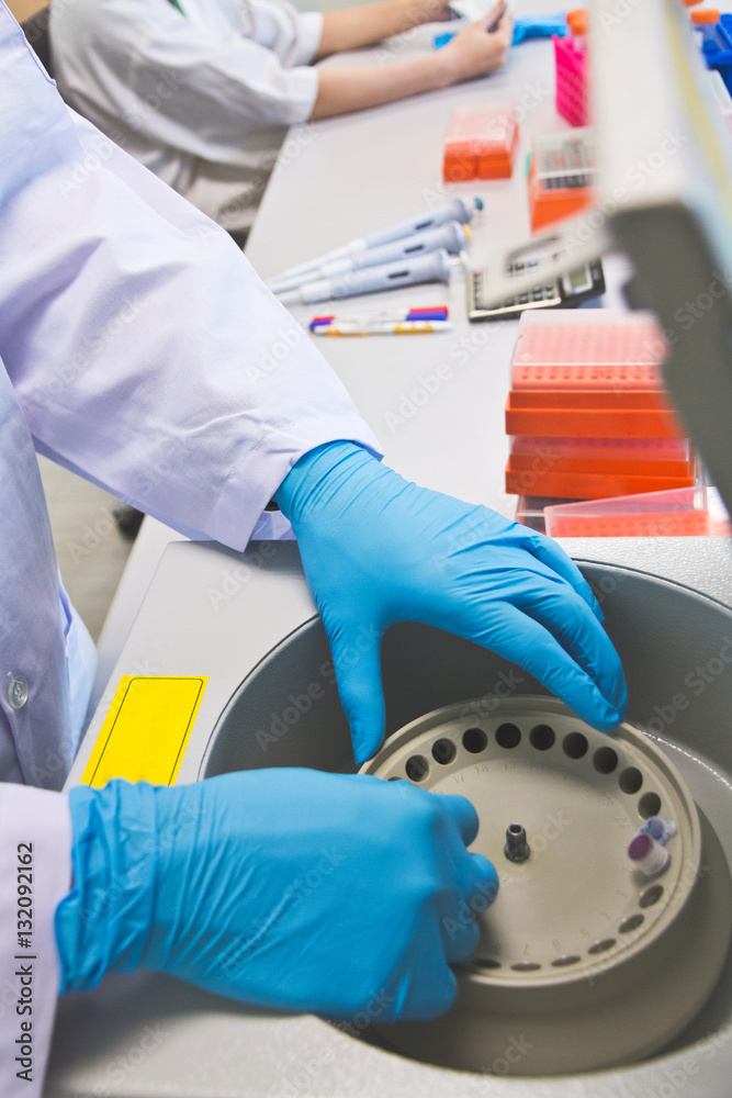 Research scientist putting test tube into real-time pcr machine Stock ...