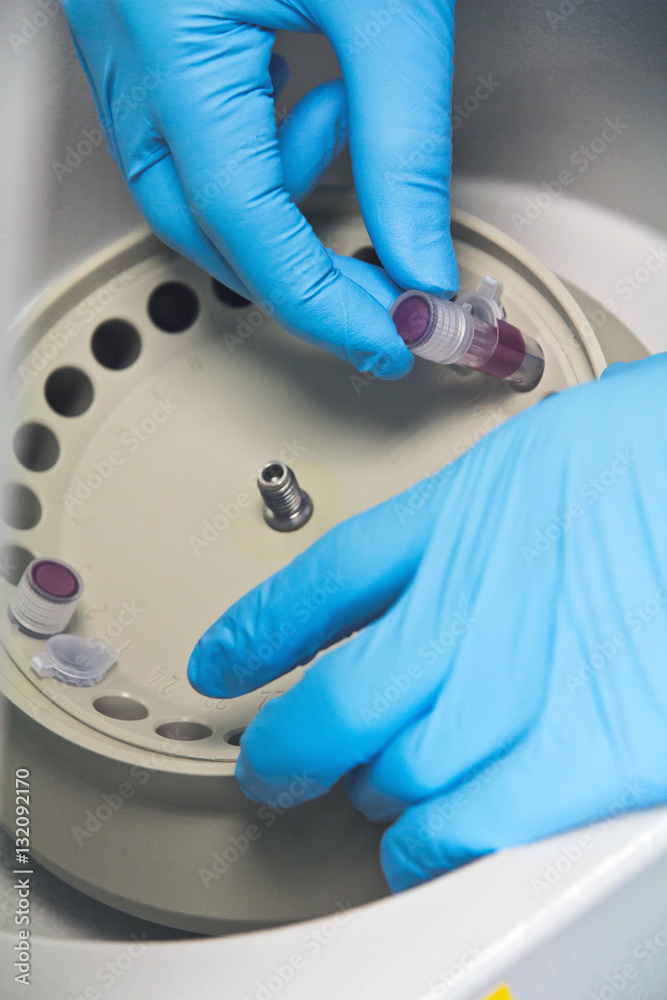 Research scientist putting test tube into real-time pcr machine Stock ...