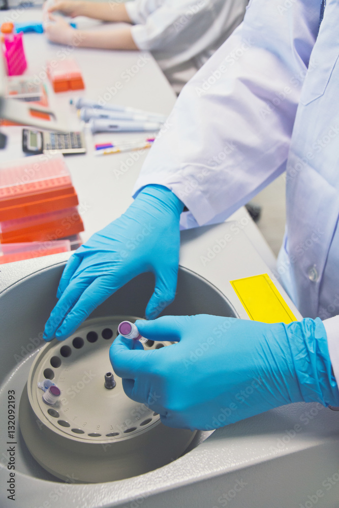 Research scientist putting test tube into real-time pcr machine Stock ...