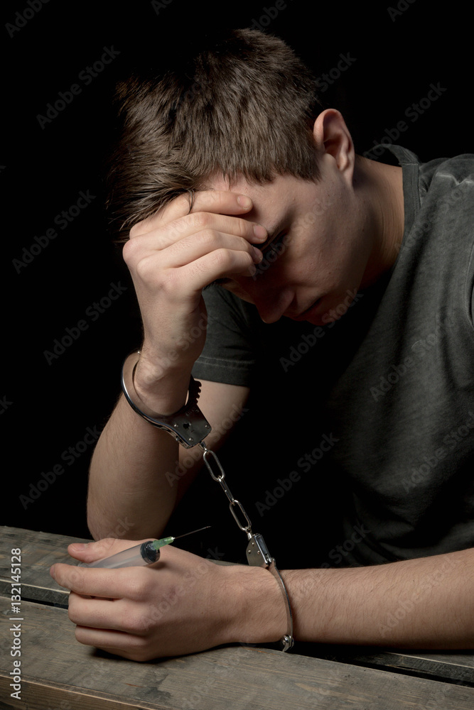 Teenage boy in handcuffs Stock Photo | Adobe Stock
