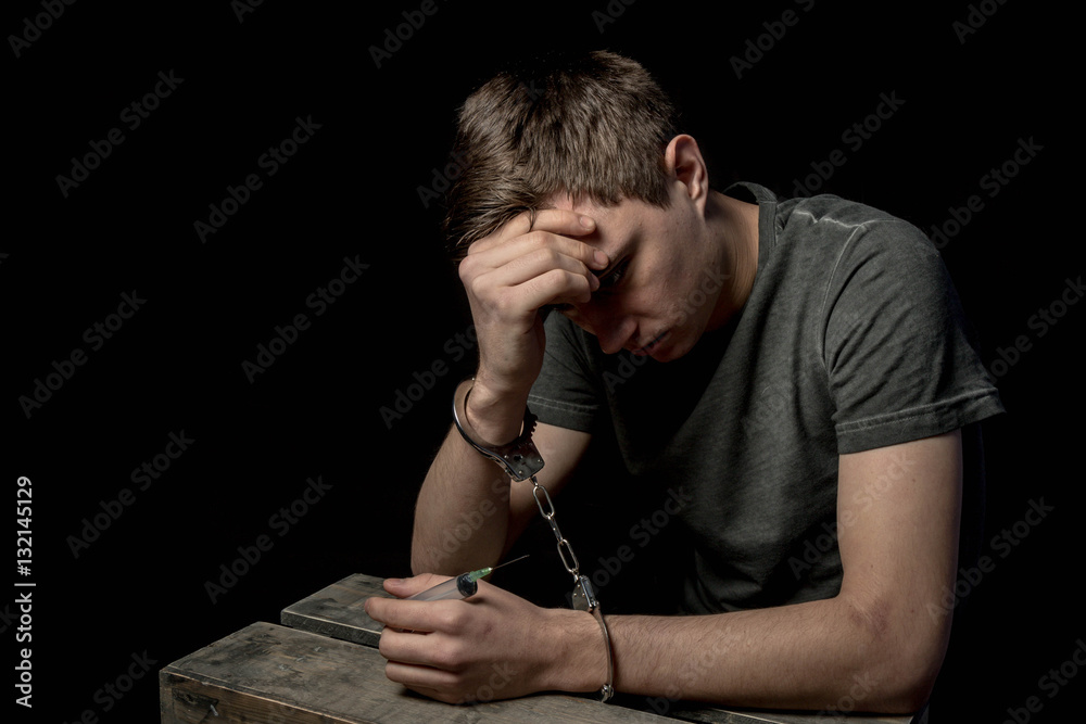 Teenage boy in handcuffs Stock Photo | Adobe Stock