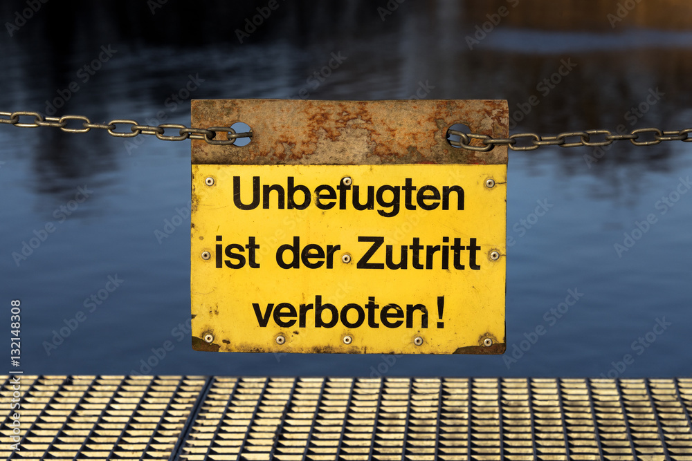 Yellow German sign on a metal chain: No access - no entry for ...
