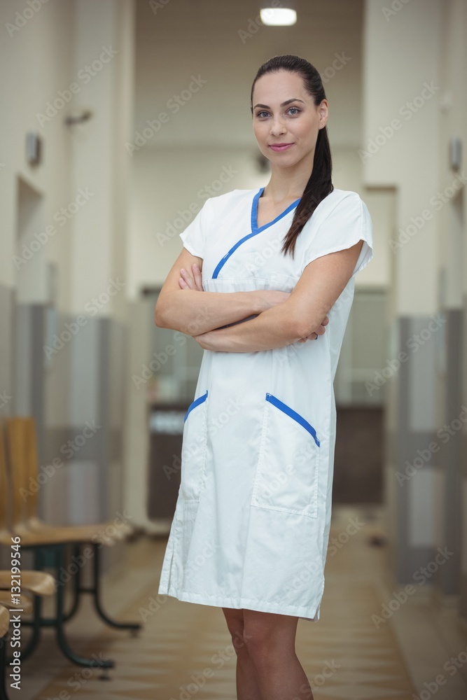 Portrait of female nurse standing in corridor Stock Photo | Adobe Stock