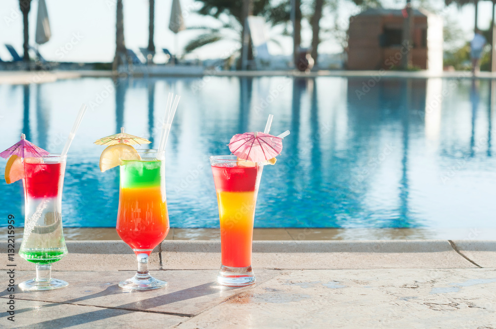 Colored cocktails on a background of water. Colorful cocktails near the ...