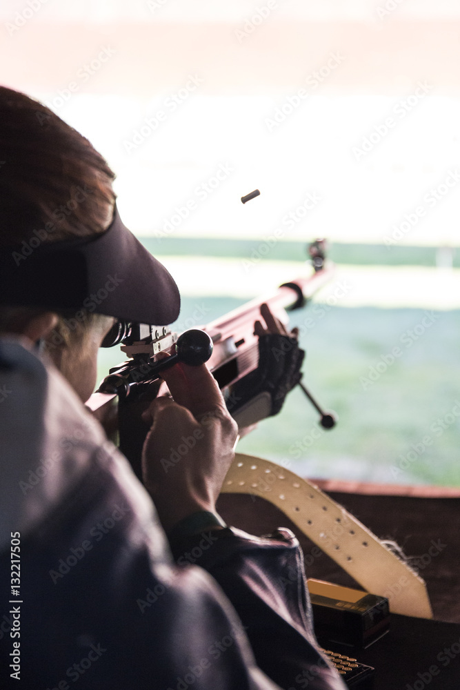 Bullet in the air after woman shooting her sporting rifle in a shooting ...