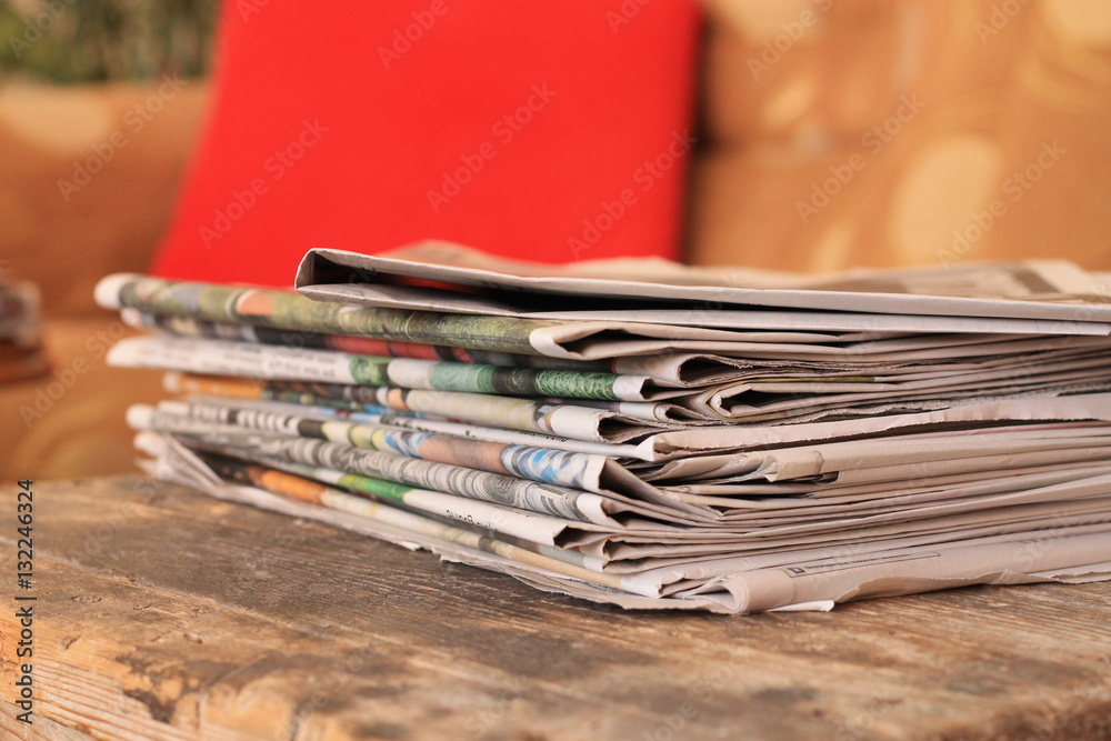 Newspapers on wooden table Stock Photo | Adobe Stock