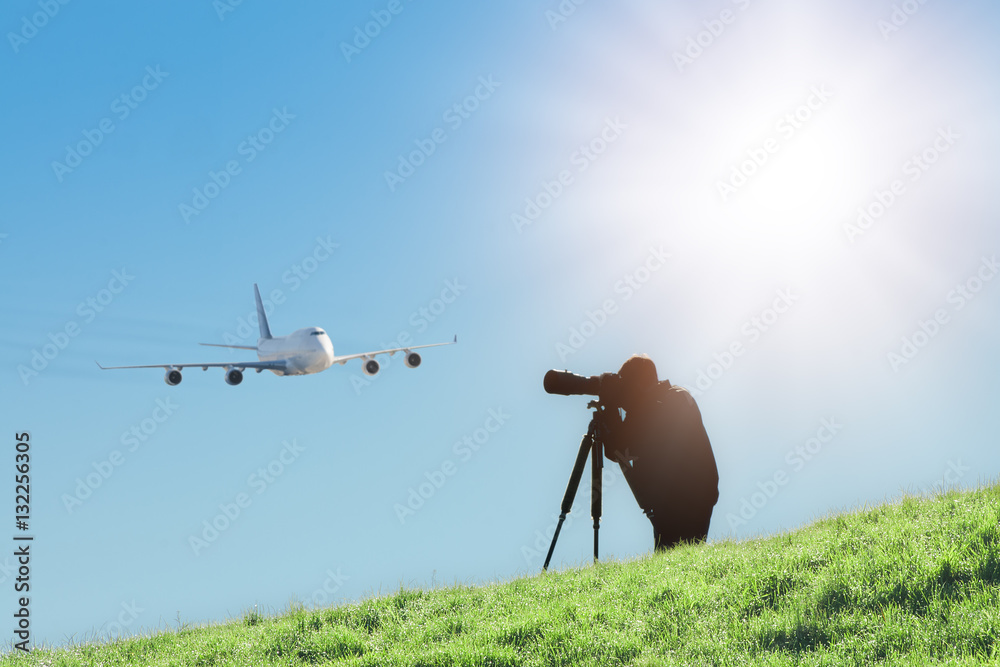 Silhouette of spotter photographer with camera and telephoto lens ...