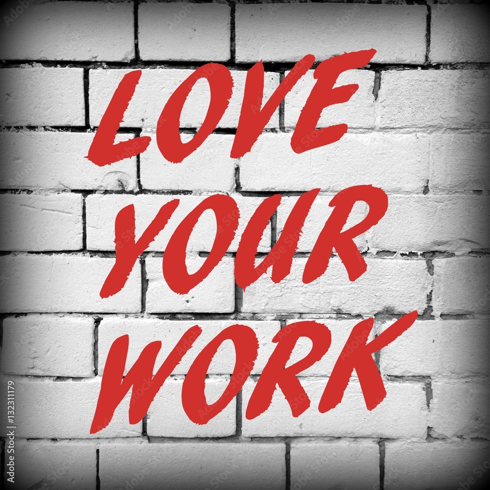 The words Love Your Work in red text on a white brick wall as a concept ...