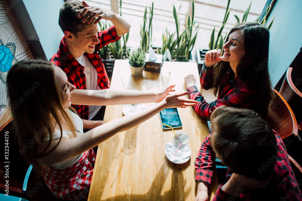 Group of young friends hanging out at a coffee shop. Young men and ...