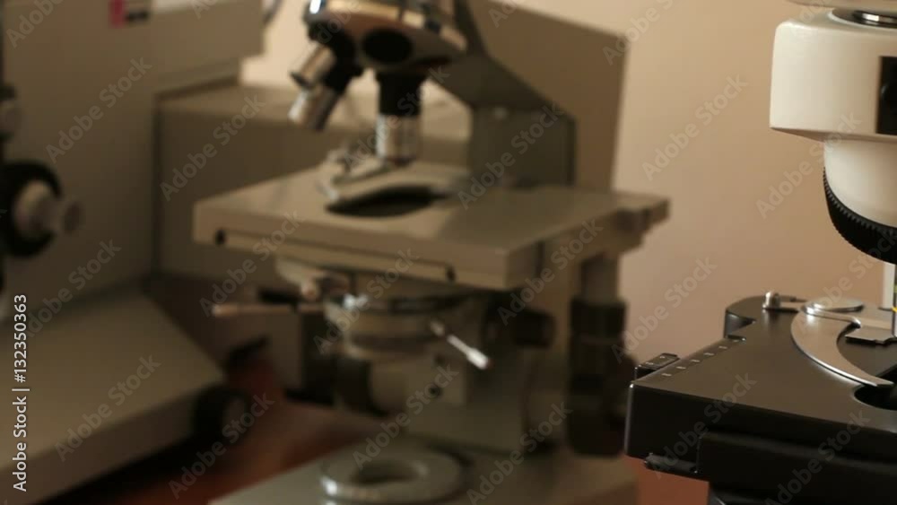 Old blurred microscopes horizontal panning. Focus on the modern ...