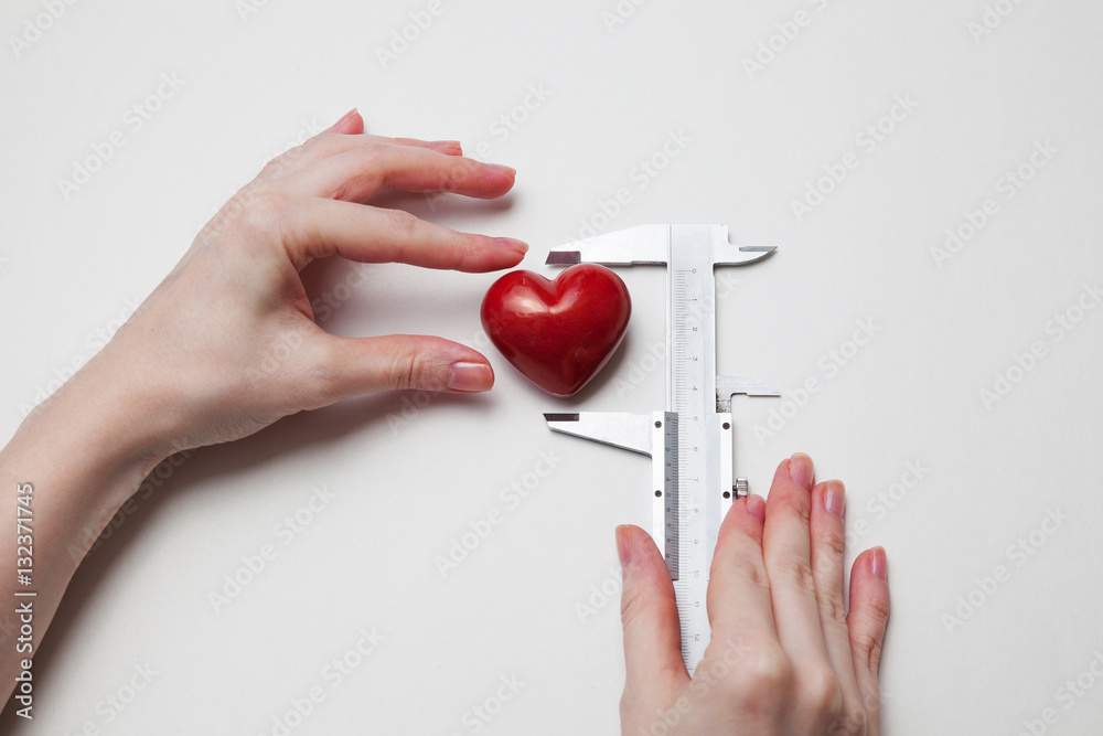 hands measuring heart with calipers Stock Photo | Adobe Stock
