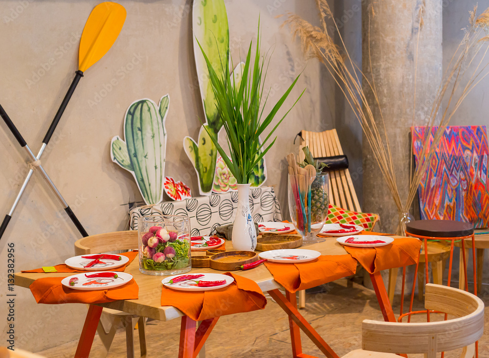 Cute restaurant interior with table, chairs and paddles on the w Stock ...