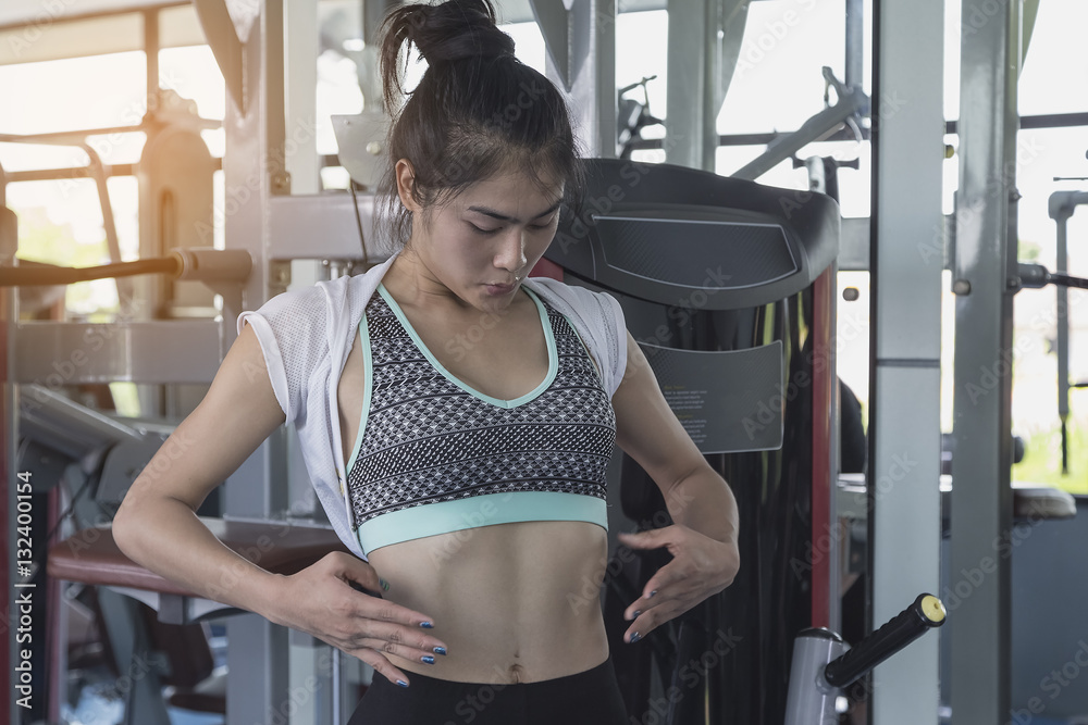 Girl exercising happily in the gym. Stock Photo | Adobe Stock