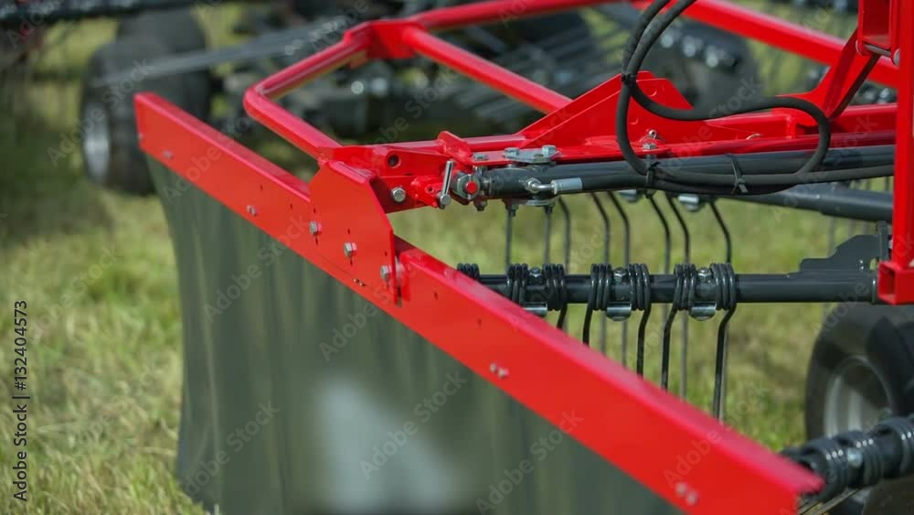 The outer part of the machinery for raking hay changes the position and ...