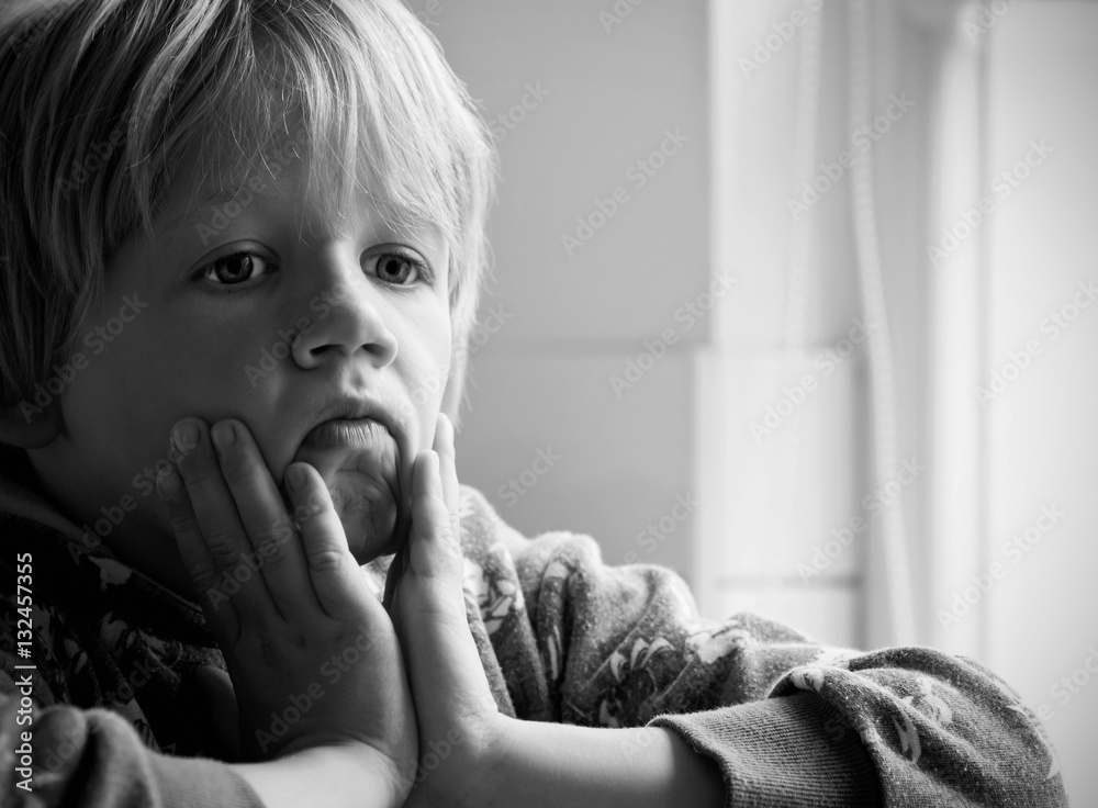Child staring aimlessly with a look of despair on his face Stock Photo ...