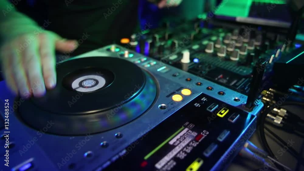 Hands of DJ which mixes music tracks with CD-players and mixer in ...