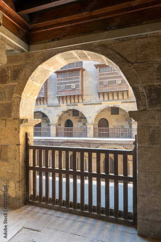 Angled view of one arch with interleaved wooden balustrades at the ...