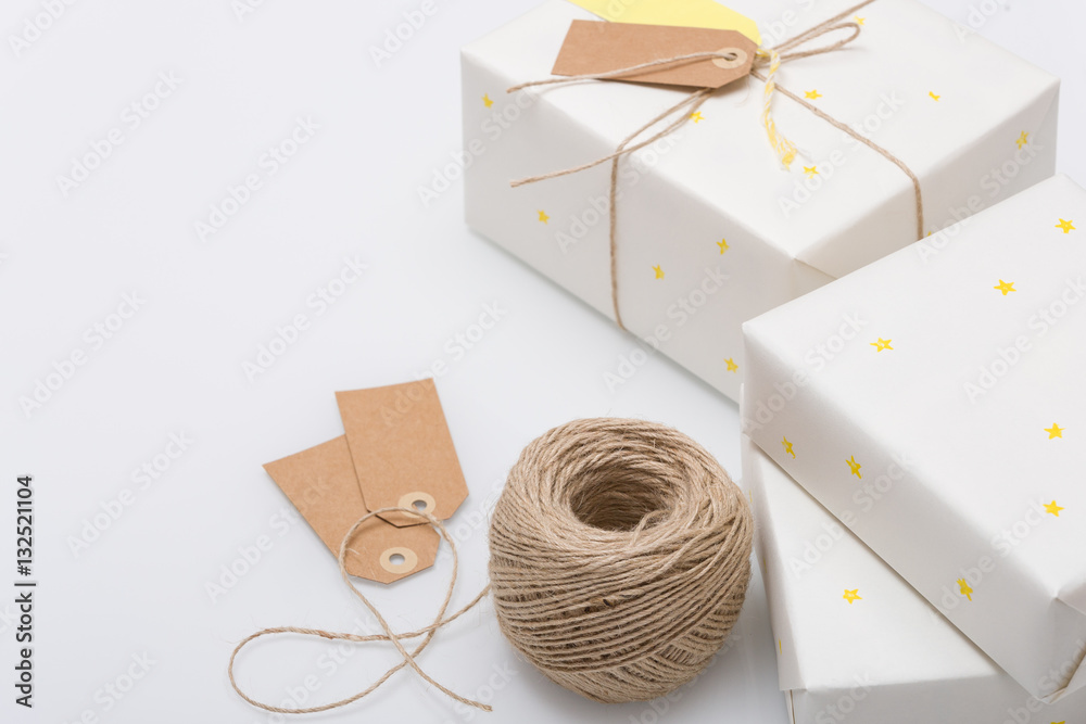 Nice present packed in white paper with small yellow stars on white ...