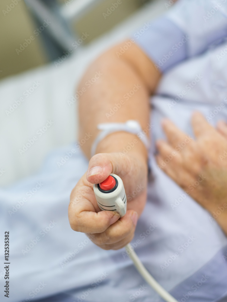 A hand holding emergency button in hospital room.Emergency button for ...