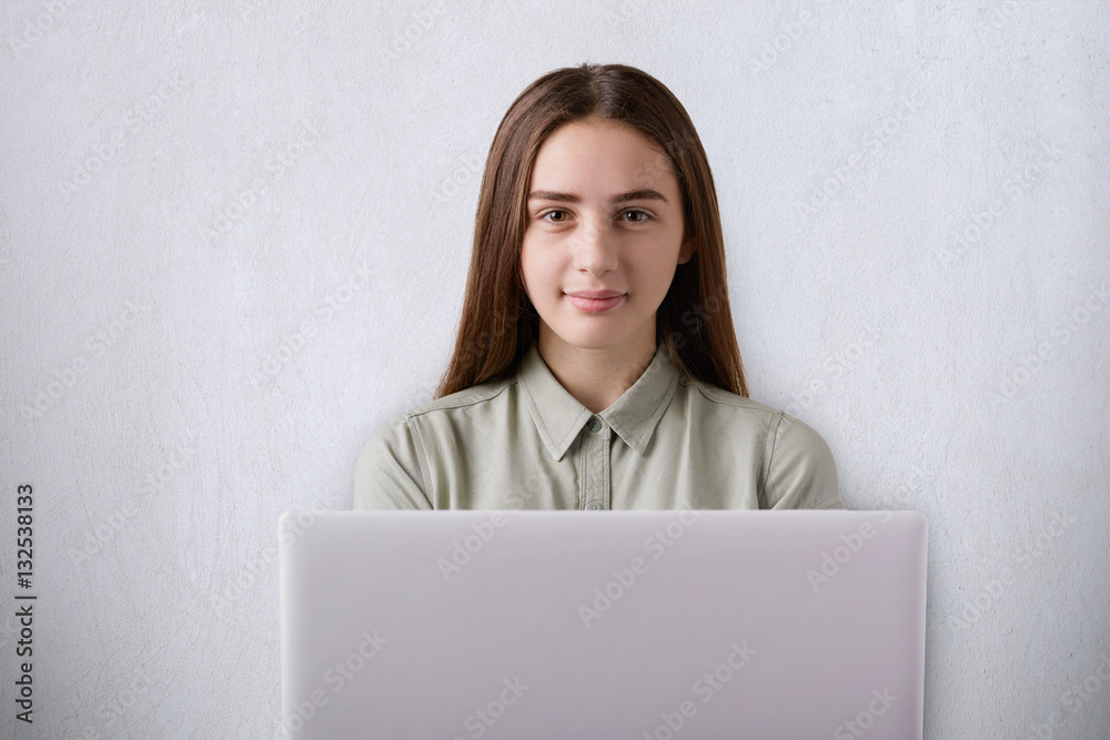 An attractive young girl wearing shirt, with dark hair and eyebrows ...