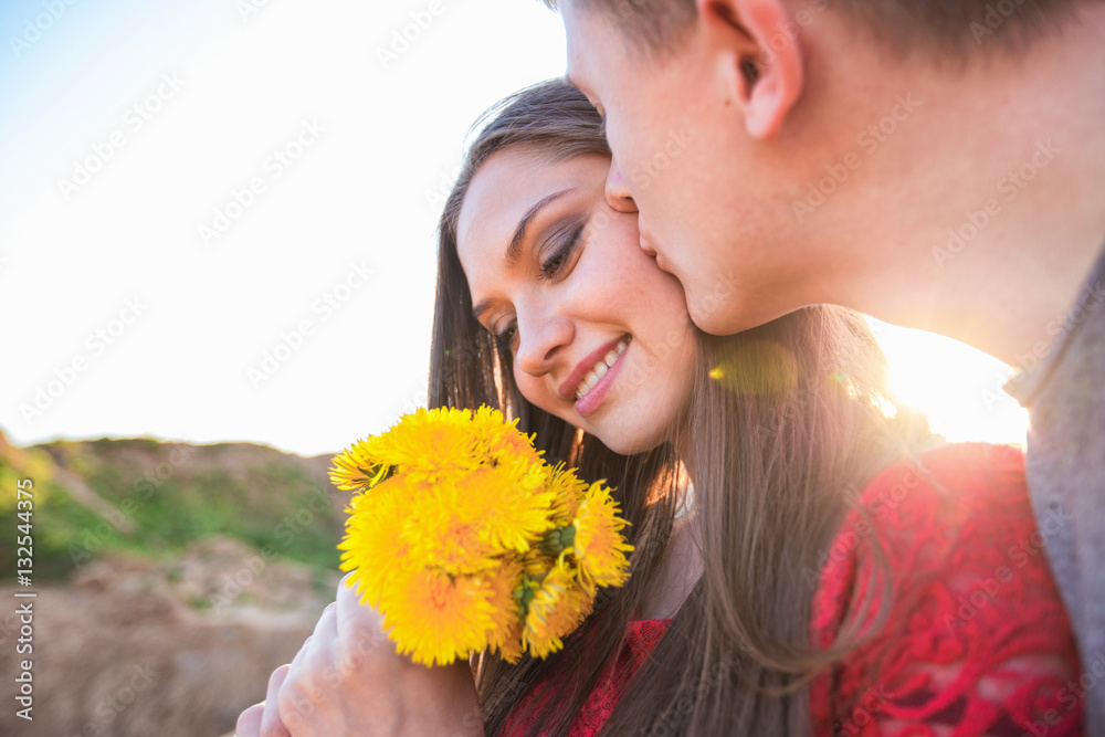 young couple. Smiling girl with light skin. Romantic mood, bouquet of ...