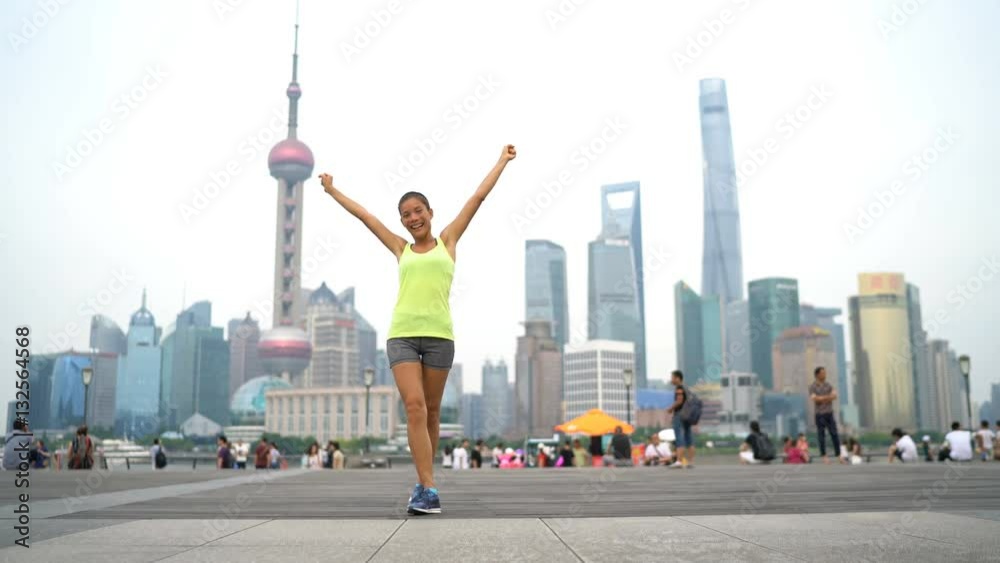 Happiness in city. Happy woman jumping of success in front of urban ...