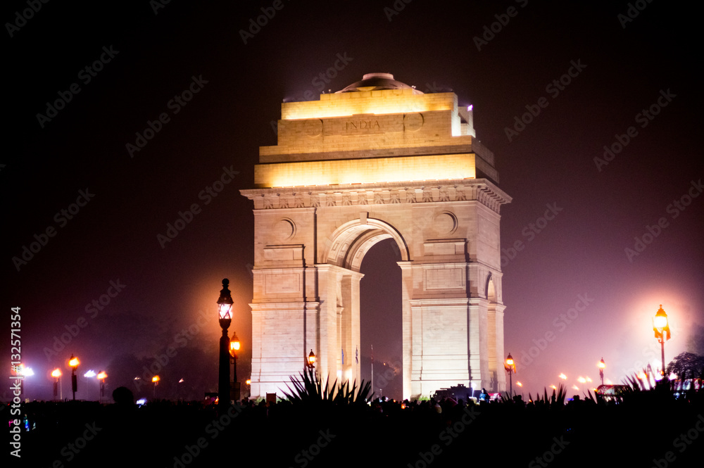 India gate at night with multicolored lights. This landmark is one of ...