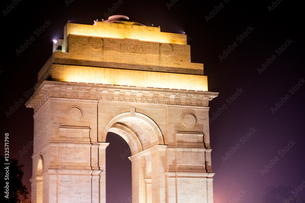 India gate at night with multicolored lights. This landmark is one of ...