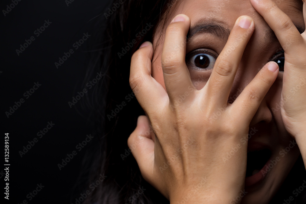 Scared woman on isolated black background Stock Photo | Adobe Stock