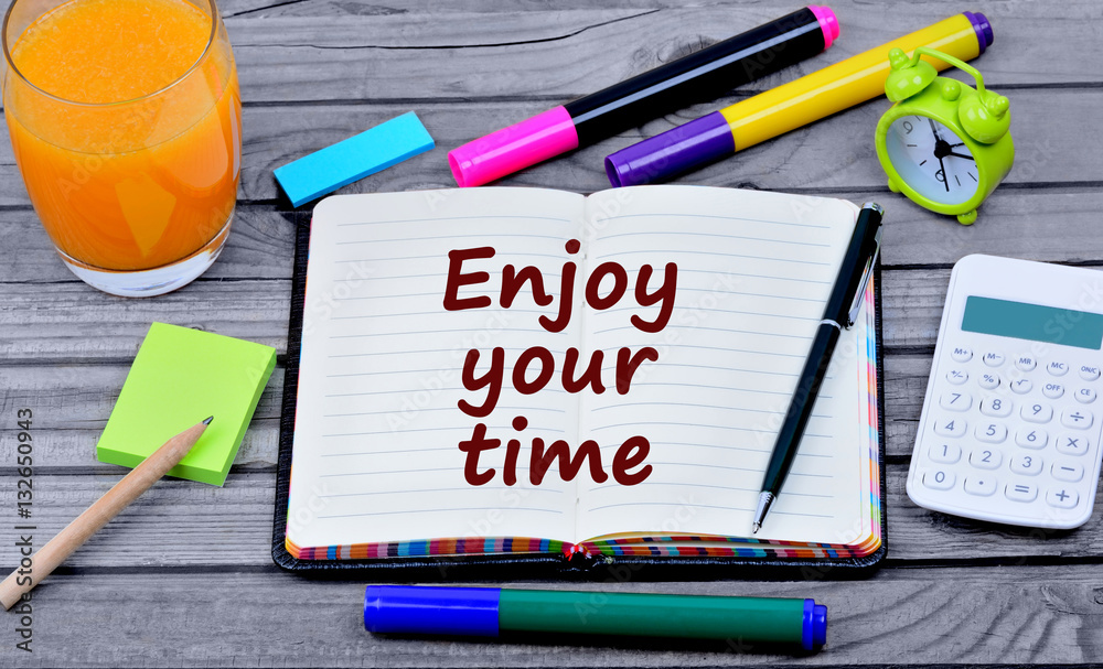 The words Enjoy your time on notebook Stock Photo | Adobe Stock