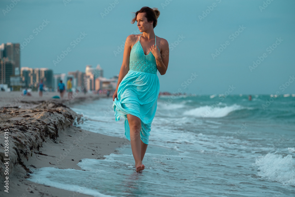 Beautiful woman walking along the South beach, Miami, USA Stock Photo ...