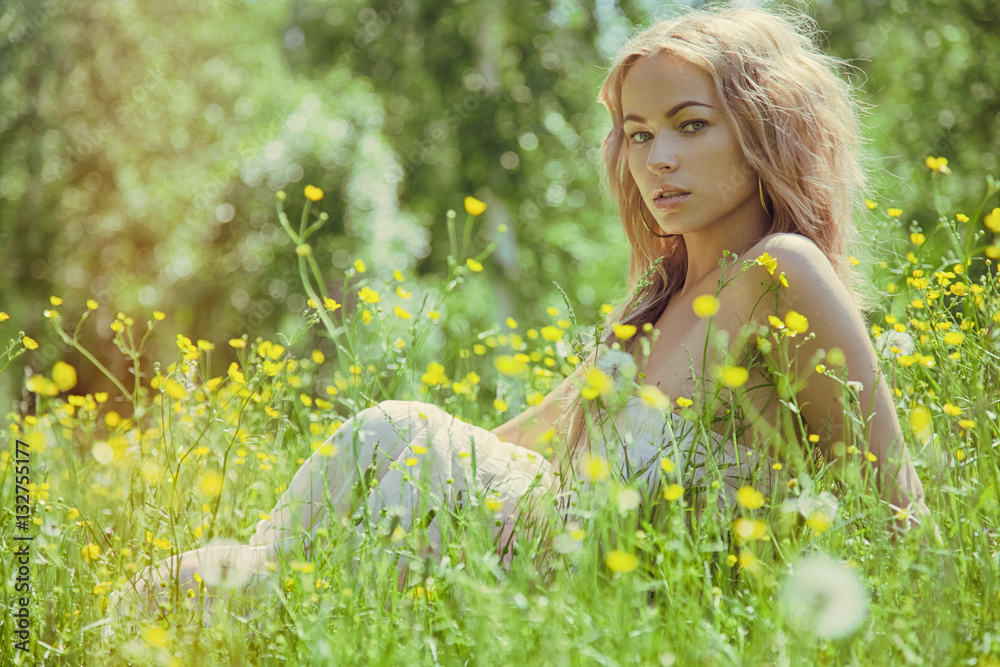 Beautiful woman outdoors enjoying nature in dress at summer meadow ...