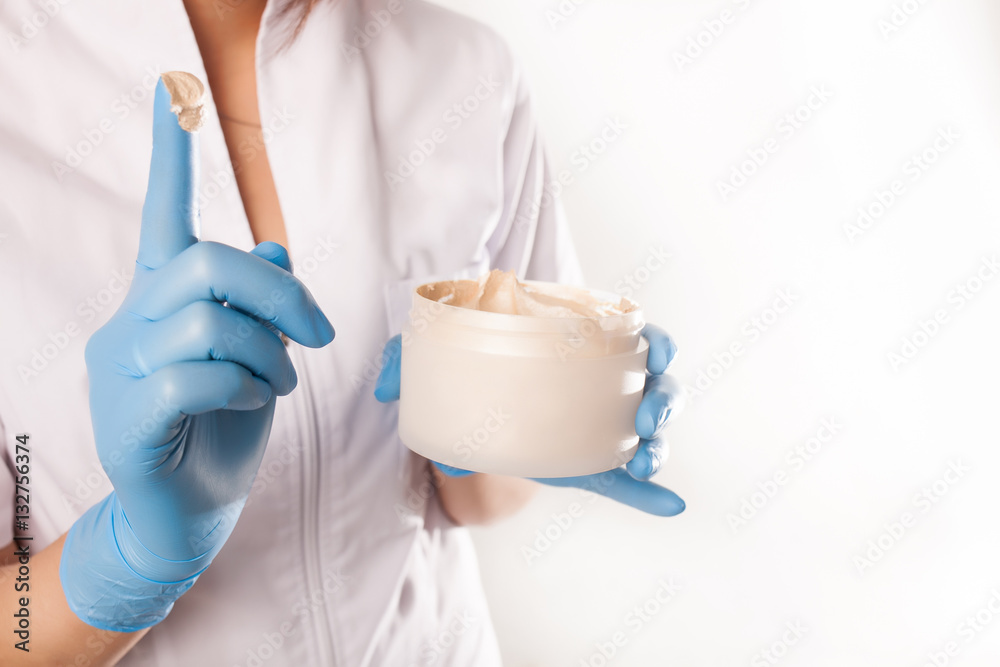 Poster topical face cream A gloved hand with ointment on one finger ...